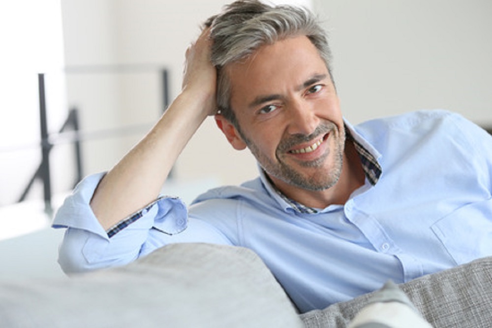 38883569 - smiling handsome 45-year-old man relaxing at home - Les ...